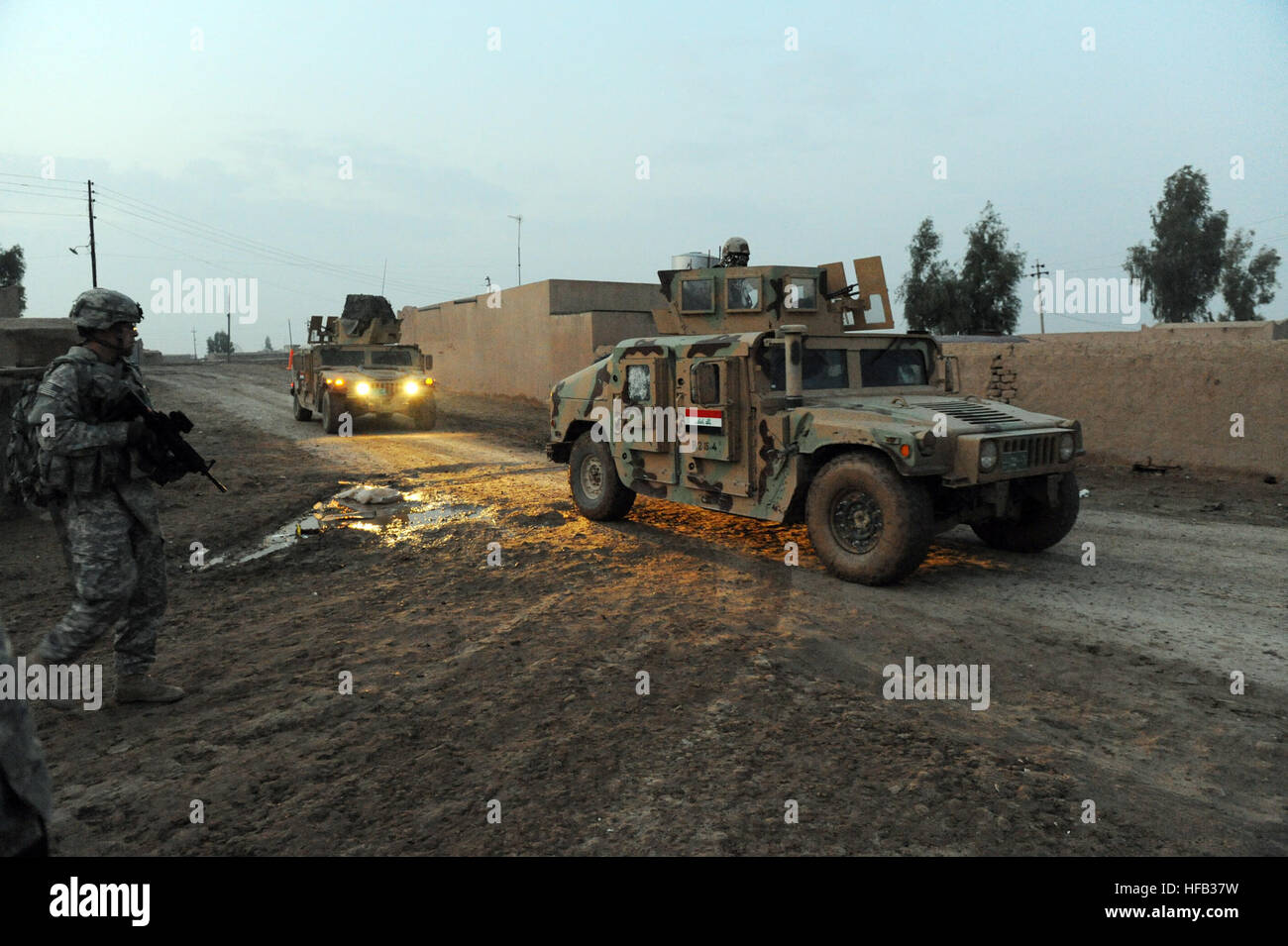 Iraqi soldiers patrol in Humvees while U.S. Soldiers from 1st Brigade ...