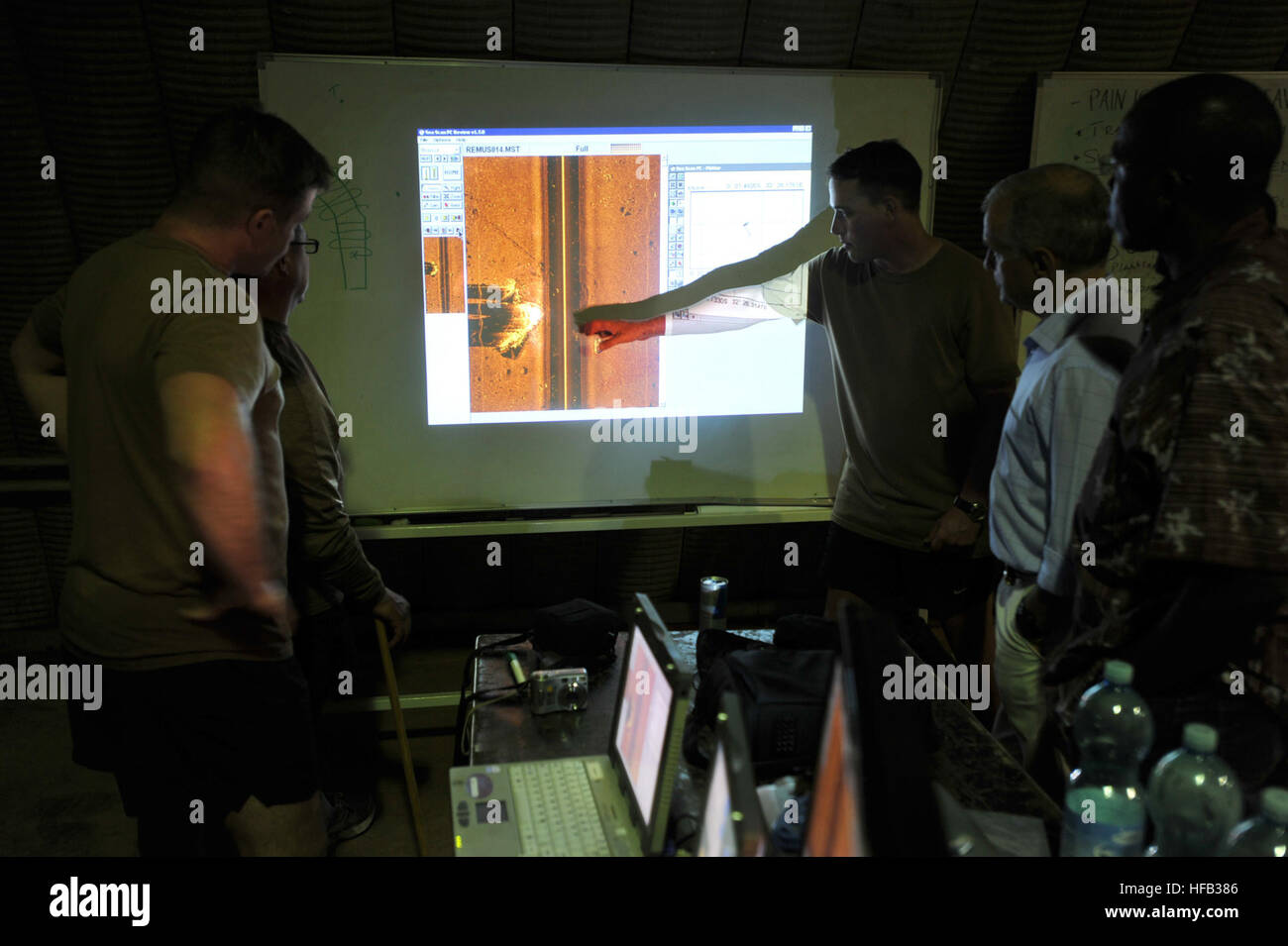Members of U.S. Navy Explosive Ordnance Disposal Mobile Unit 8 give a ...