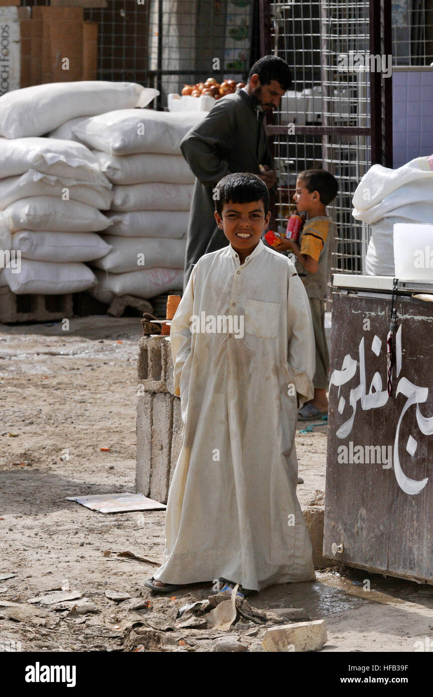 An Iraqi boy looks to the camera while U.S. Soldiers from Alpha Company ...