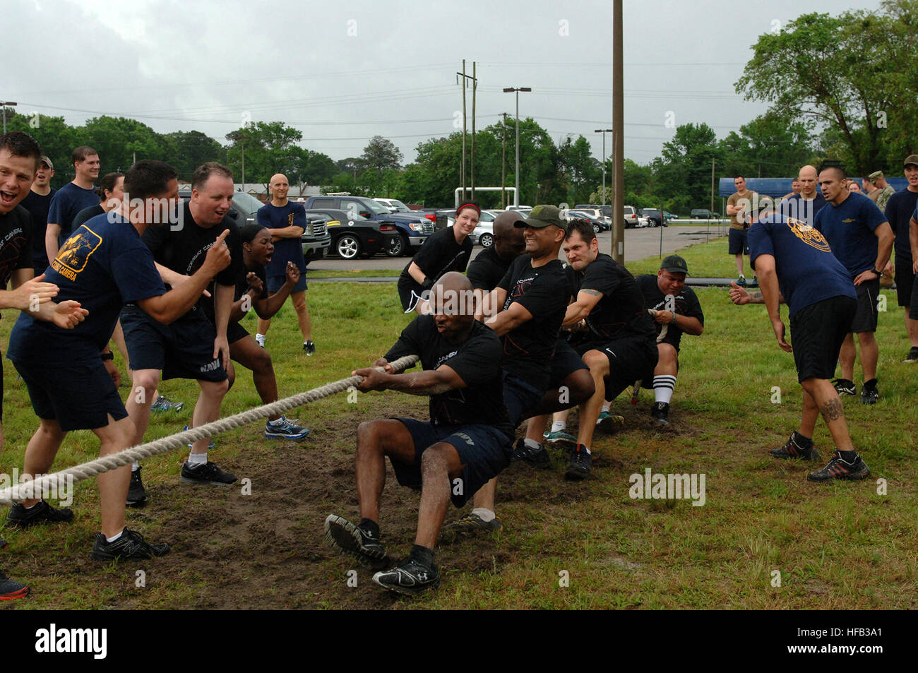 Navy Expeditionary Combat Camera Sailors participate in a tug of war ...