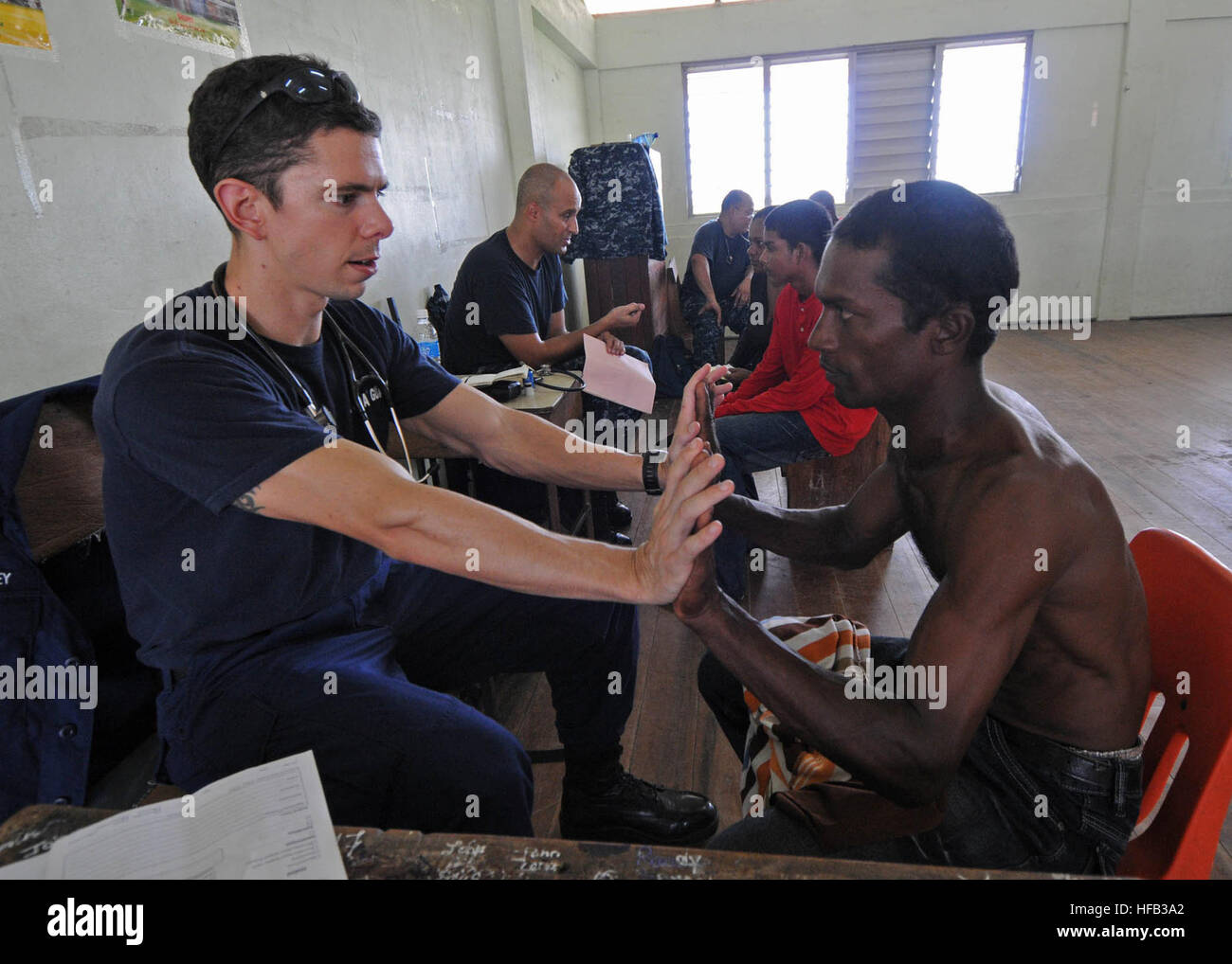 U.S. Coast Guard Lt. j.g. Jeff McCroskey, left, a physician assistant ...