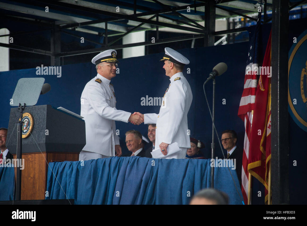 Commandant of Midshipmen U.S. Navy Capt. Robert E. Clark II, standing left, shakes hands with ...