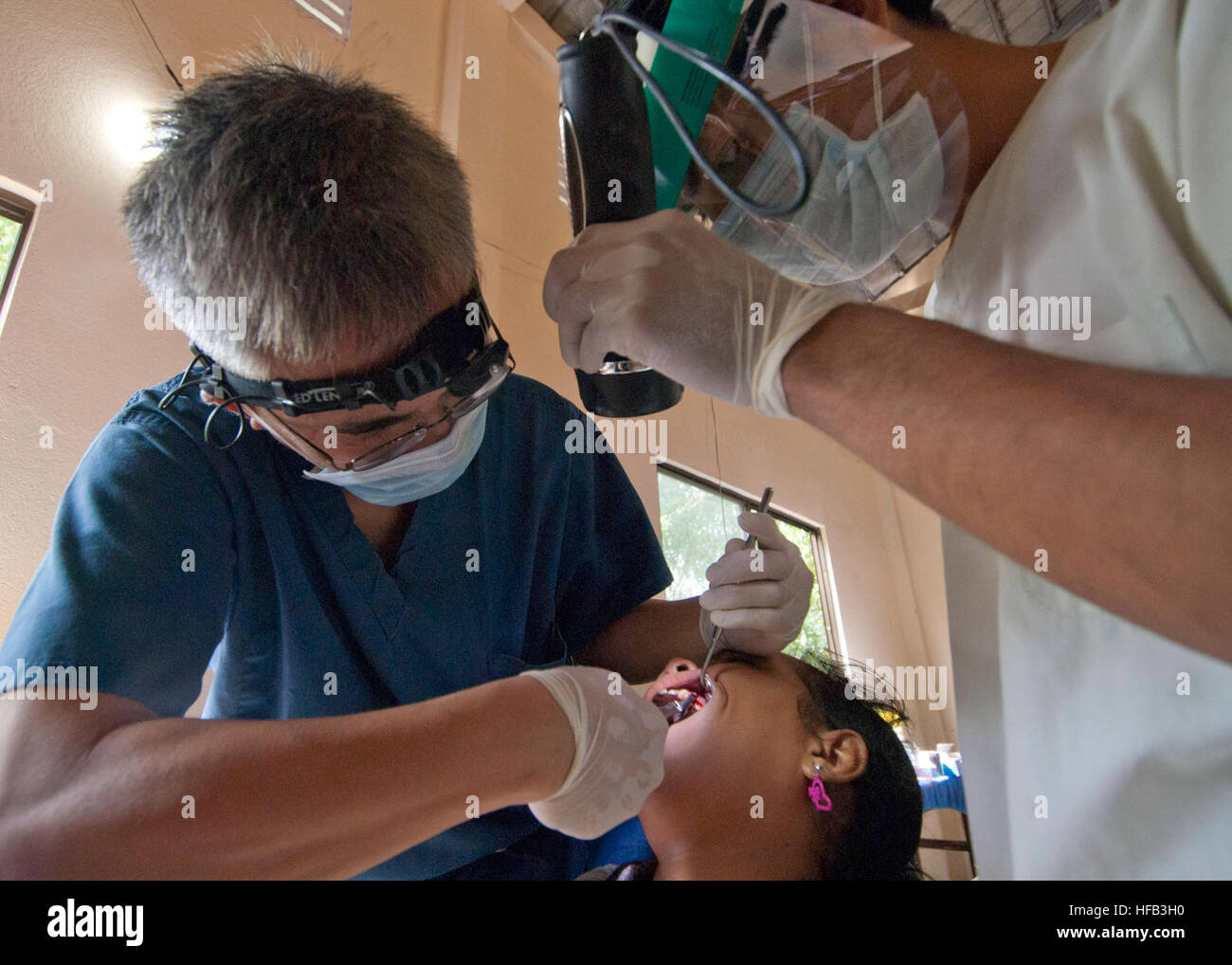 U.S. Navy dentist Lt. Cdr. Vincent Do, left, and Royal Cambodian Army ...