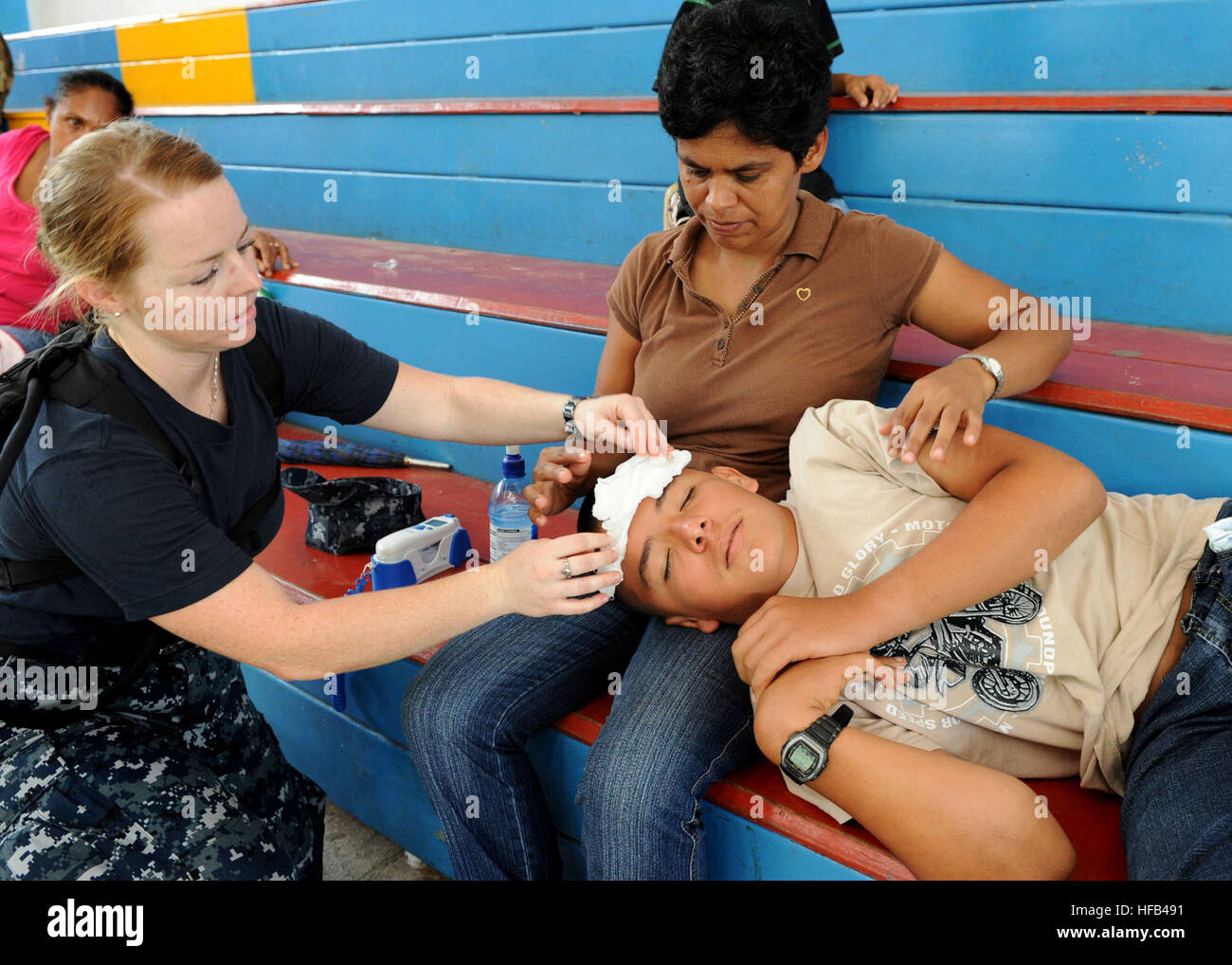 Petty Officer 2nd Class Jennifer Bell, hospital corpsman, places a cold ...