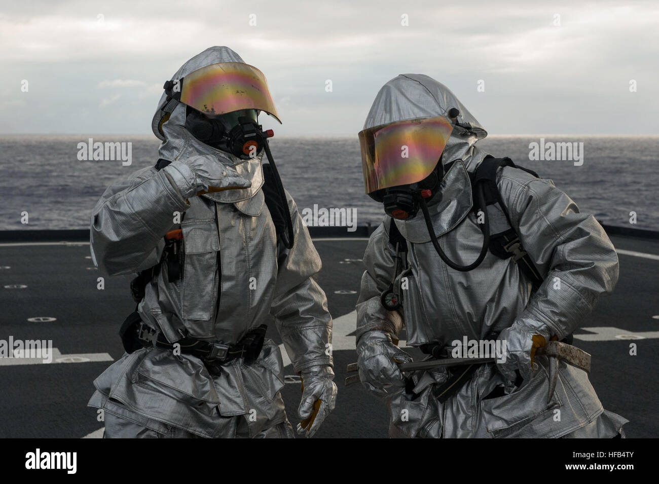 Sailors don proximity suits during a crash and salvage fire drill on ...