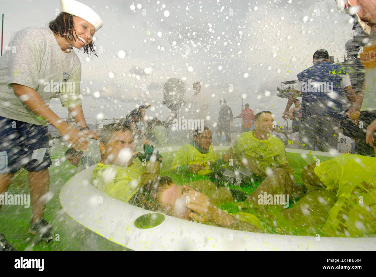 U.S. Sailors and Marines participate in a crossing the line ceremony ...