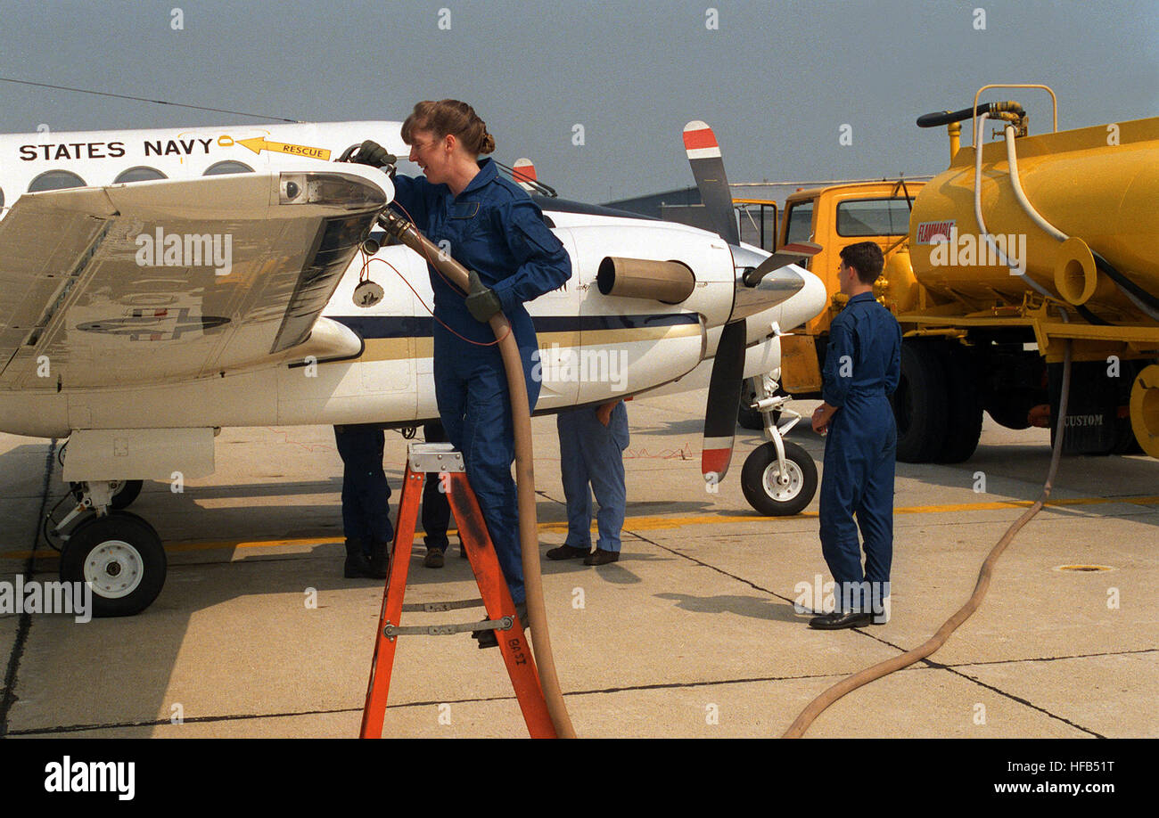 Aviation Machinist's Mate 2nd Class Crystal Wilson refuels a C-12 Huron aircraft. Crystal Wilson ...