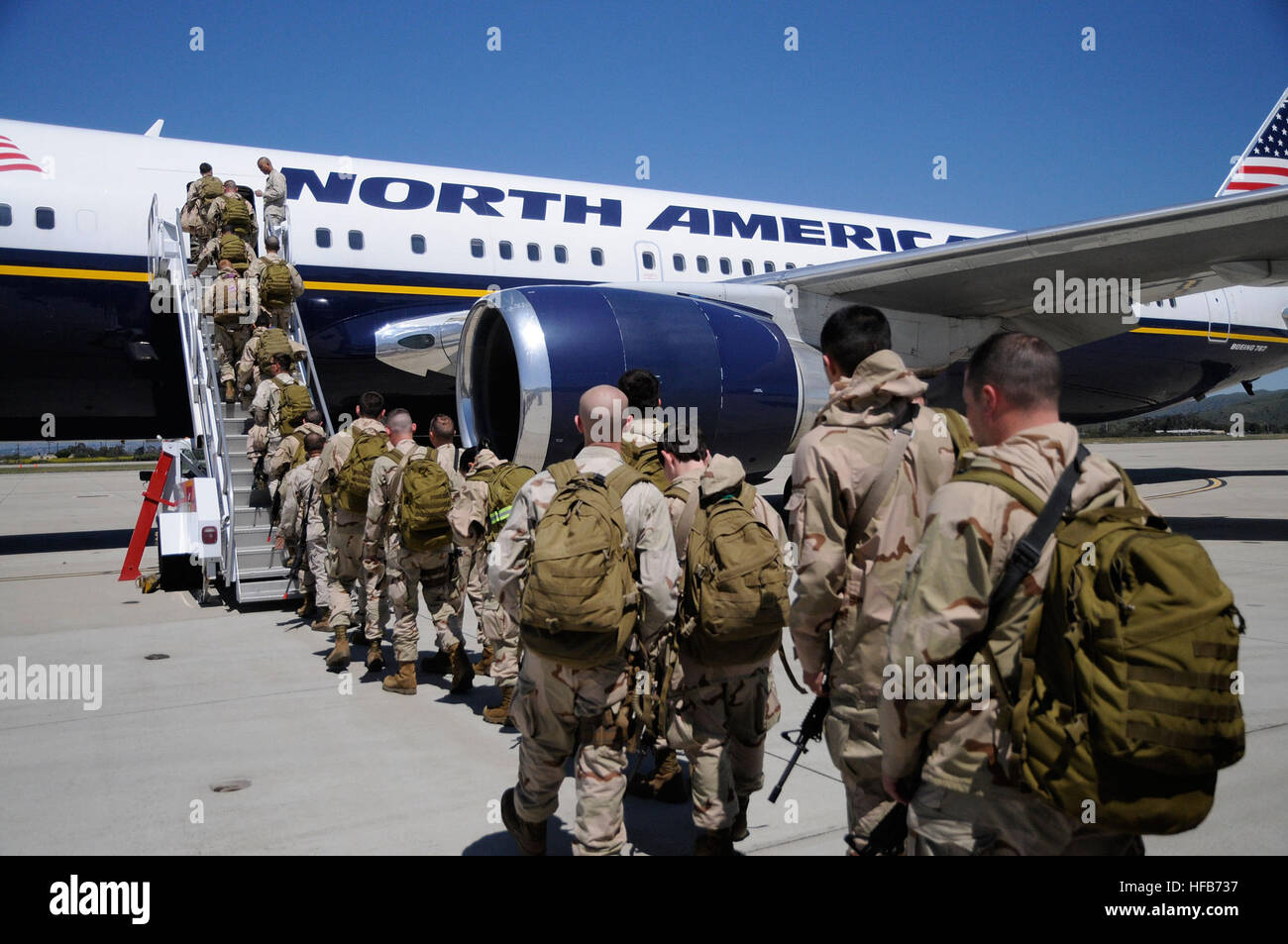 Seabees assigned to Naval Mobile Construction Battalion 5 board a plane ...