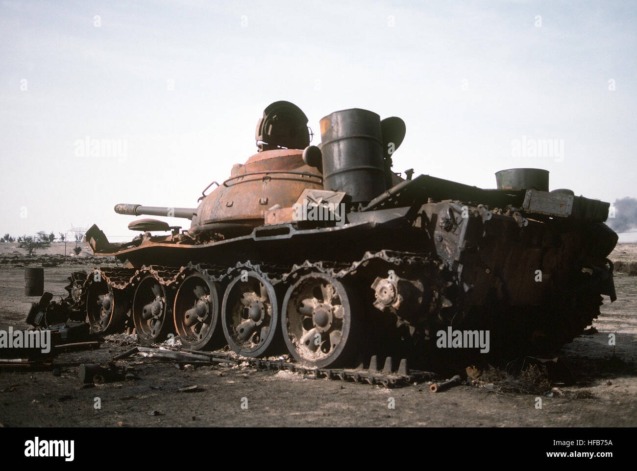 A burned-out Iraqi T-55 main battle tank lies abandoned at the edge of ...