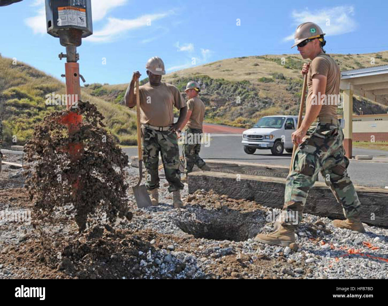 Digging holes on Cable Beach, Guantanamo Stock Photo - Alamy
