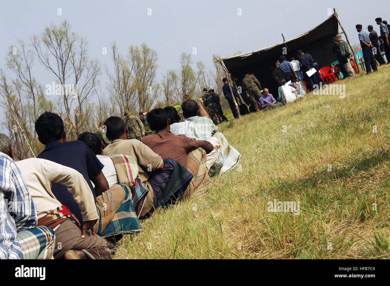 On this small Island fisherman form a line in front of a medical tent ...