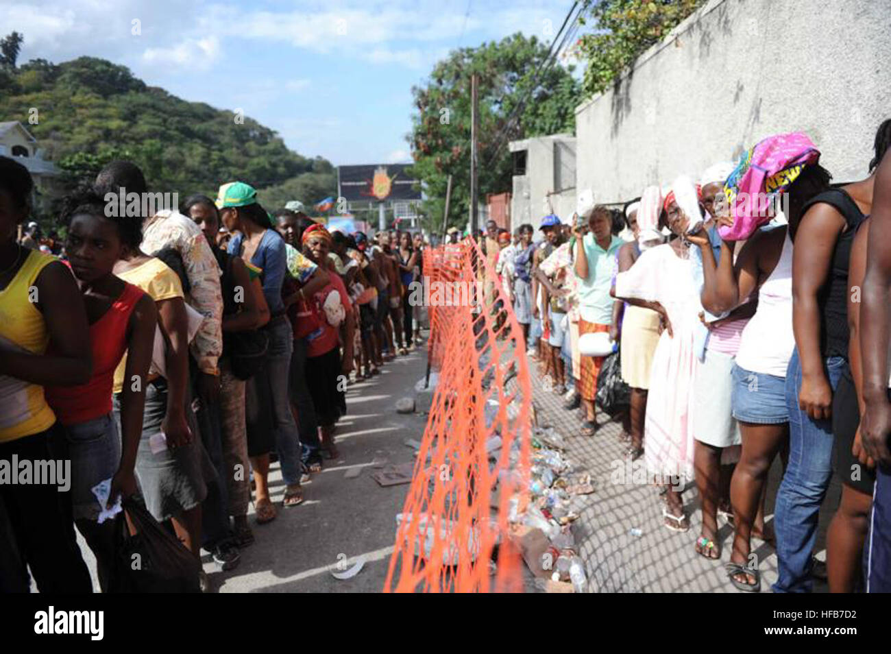 Earthquake survivors receive 50-pound bags of rice from the Irish ...