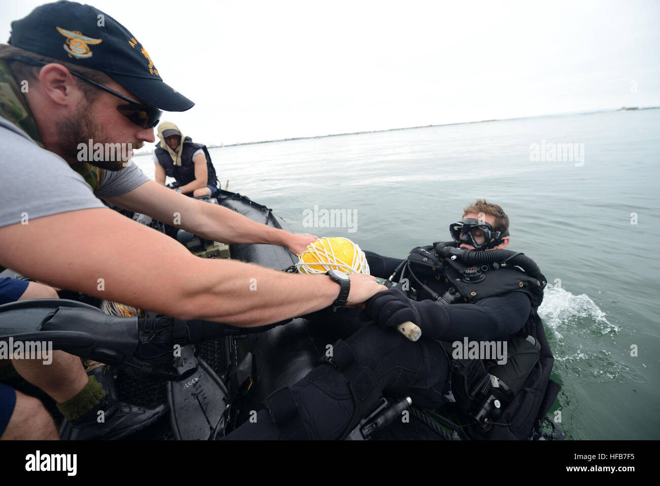 A diver from Australian Clearance Dive Team (AUSCDT) 4 enters the water ...