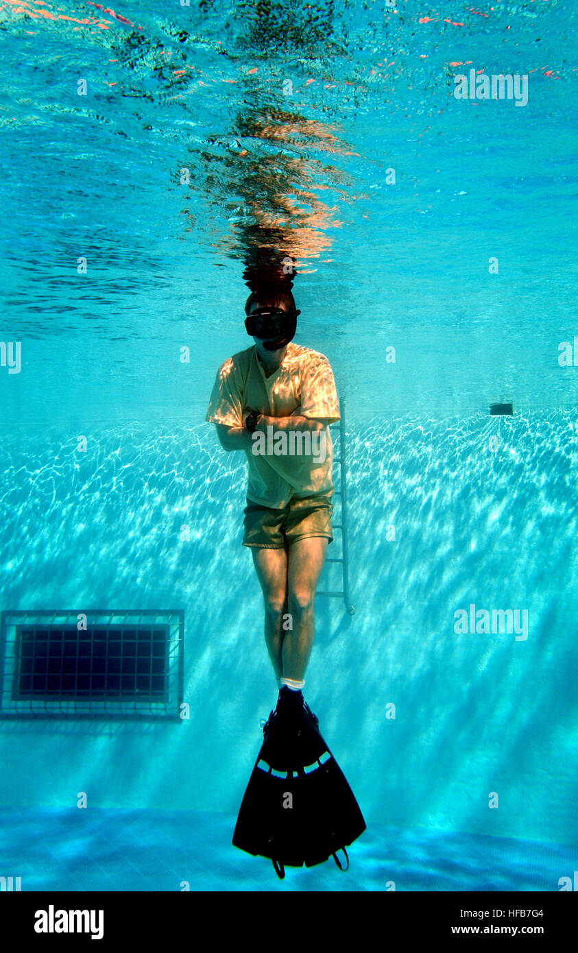 EOD Instructor BM1 (EOD/SW/PJ) Travis Bivens hangs motionless as a ...