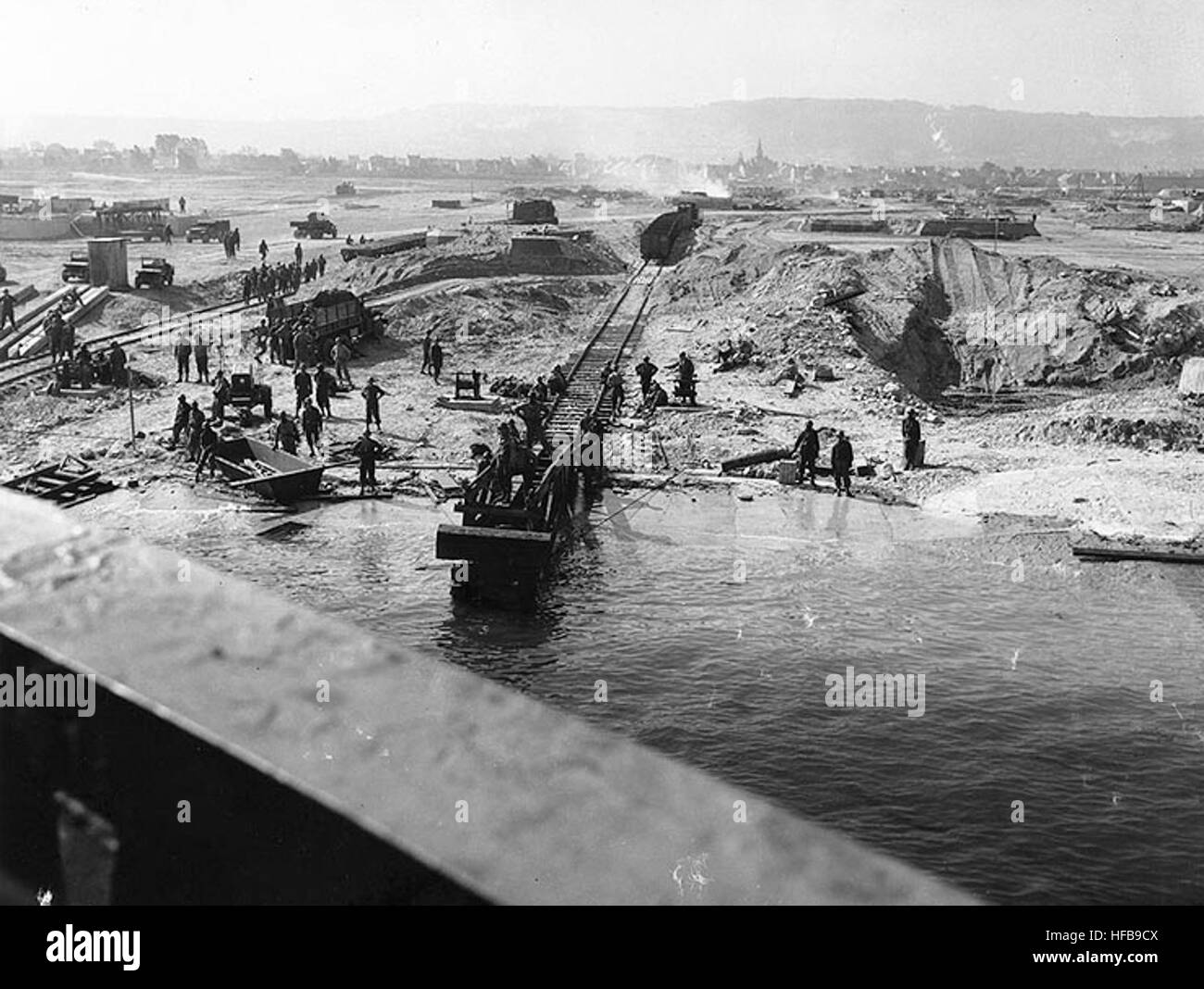 Engineers construct a rail line on Normandy beach in June 1944 ...