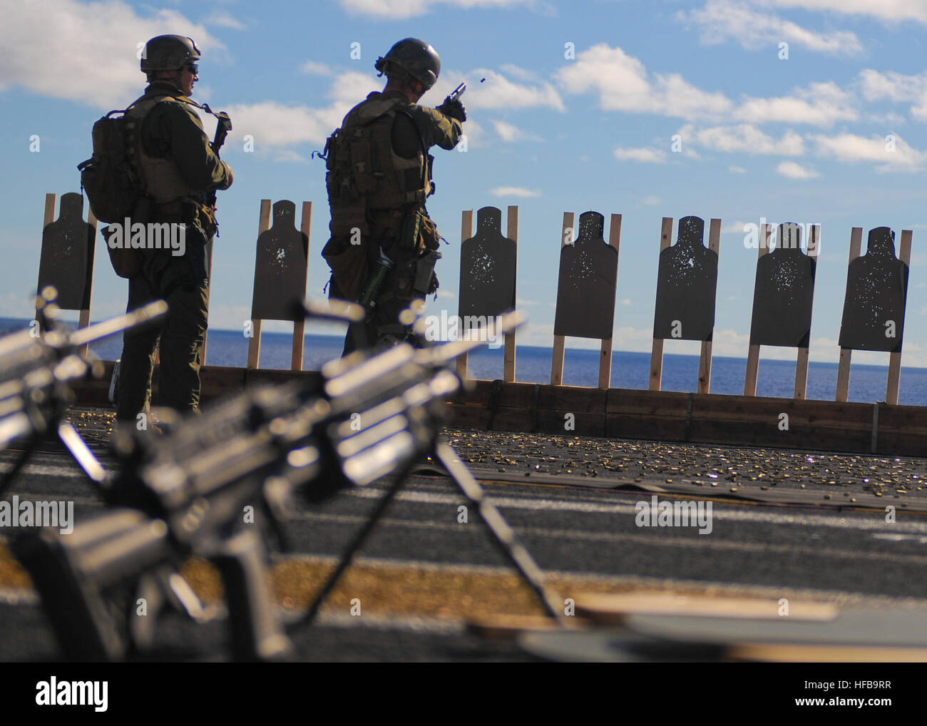 Marines assigned to the 31st Marine Expeditionary Unit fire handguns on ...