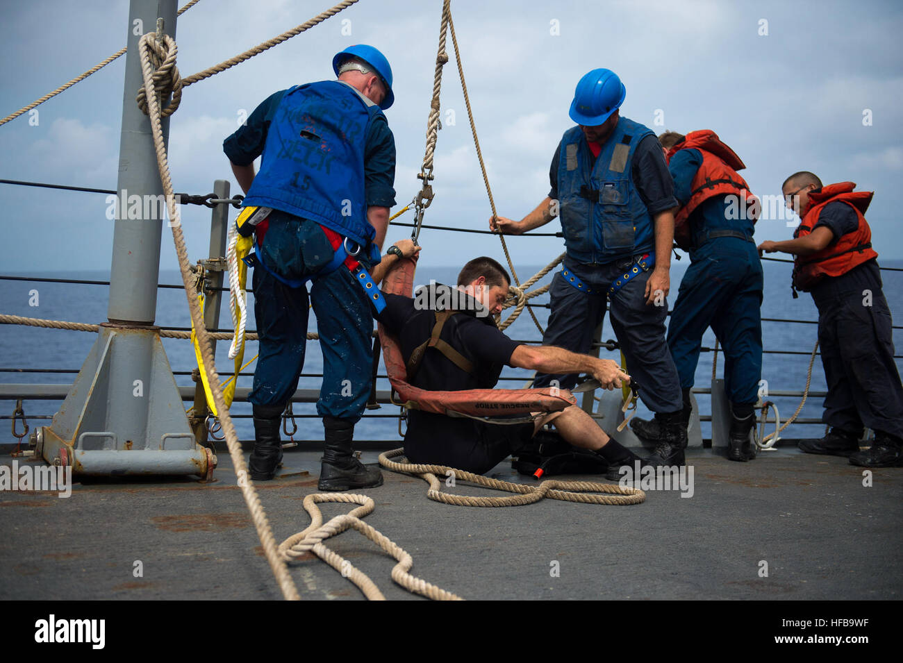 U.S. Navy Sonar Technician 1st Class Joshua Newcomb, center, a search ...
