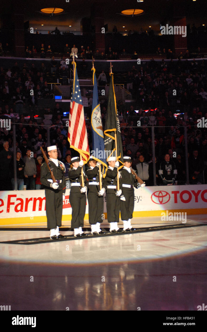 The aircraft carrier USS Ronald Reagan's Honor Guard present the colors ...