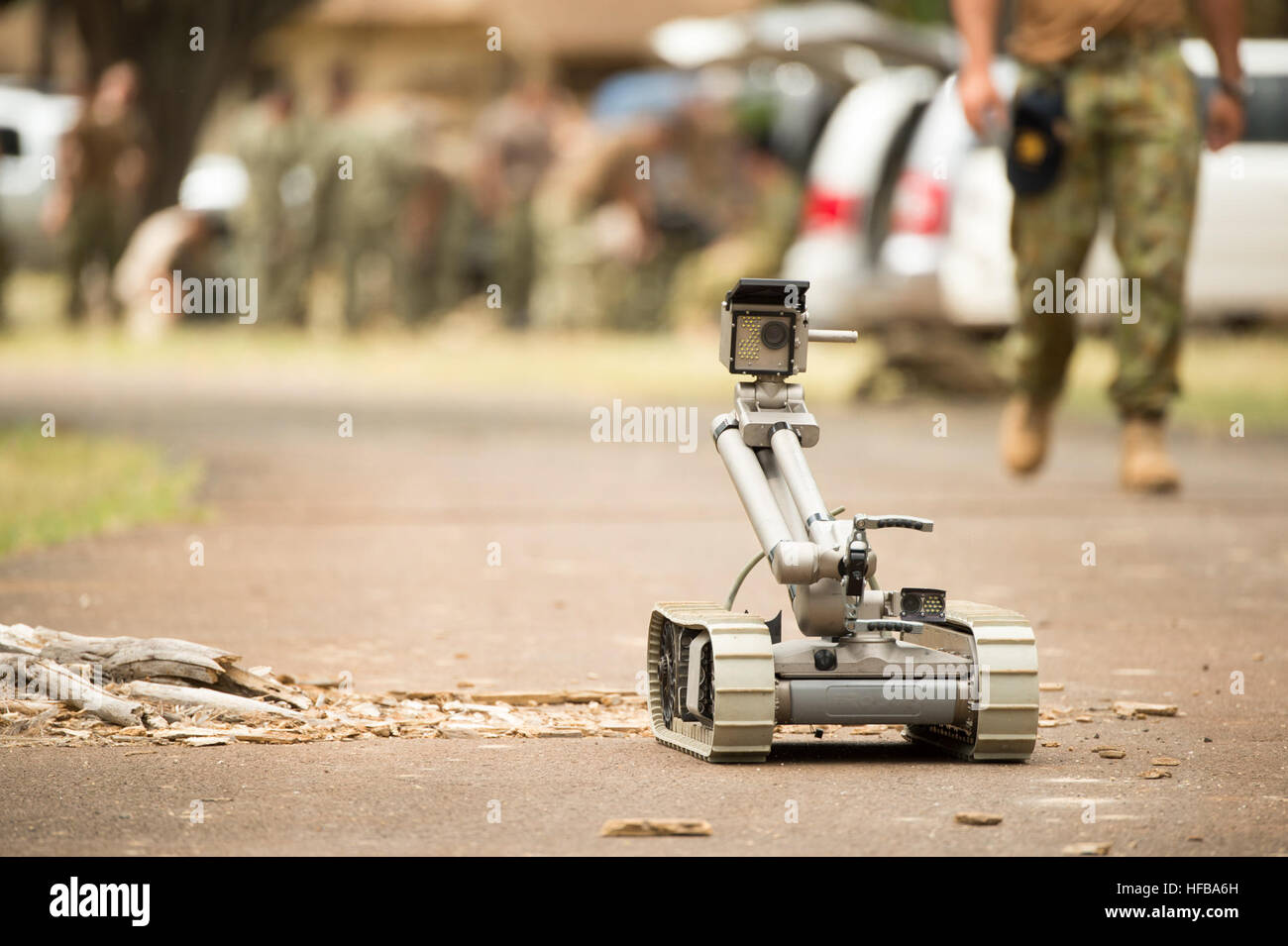 A U.S. Navy Packbot remote vehicle travels down a road during vehicle ...