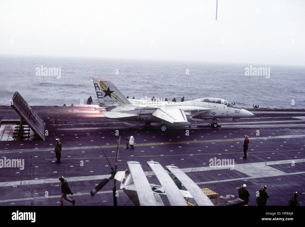 An F-14 Tomcat aircraft is launched from the deck of the aircraft ...