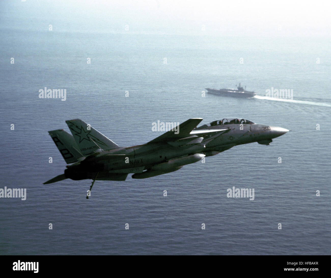 A Fighter Squadron 33 (VF-33) F-14A Tomcat aircraft banks into a turn ...