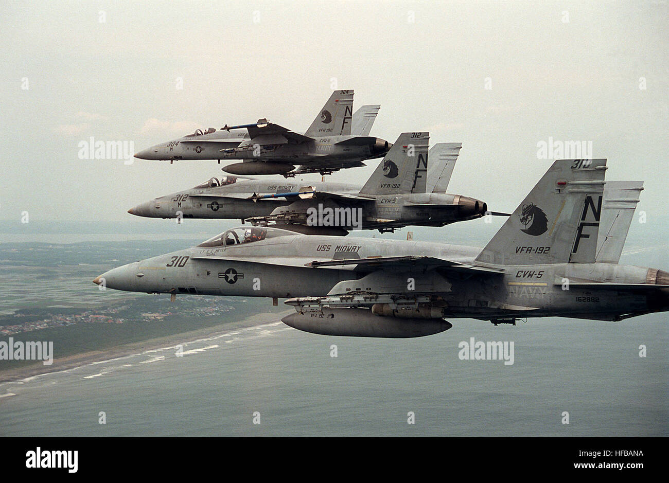 An air-to-air left side view of three F/A-18A Hornet aircraft from ...
