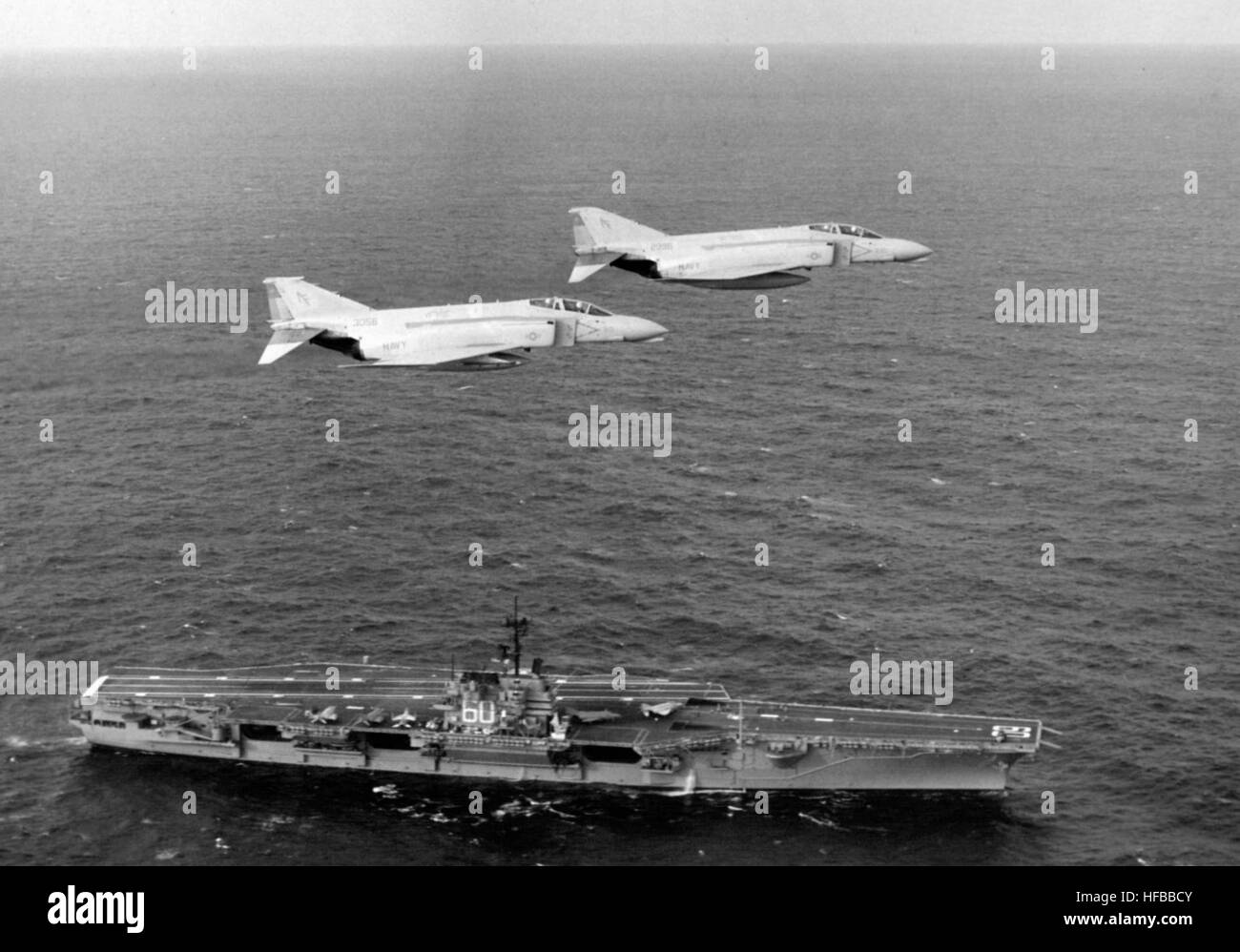 F-4N Phantom IIs of VF-202 fly over USS Saratoga (CV-60), illustrating ...