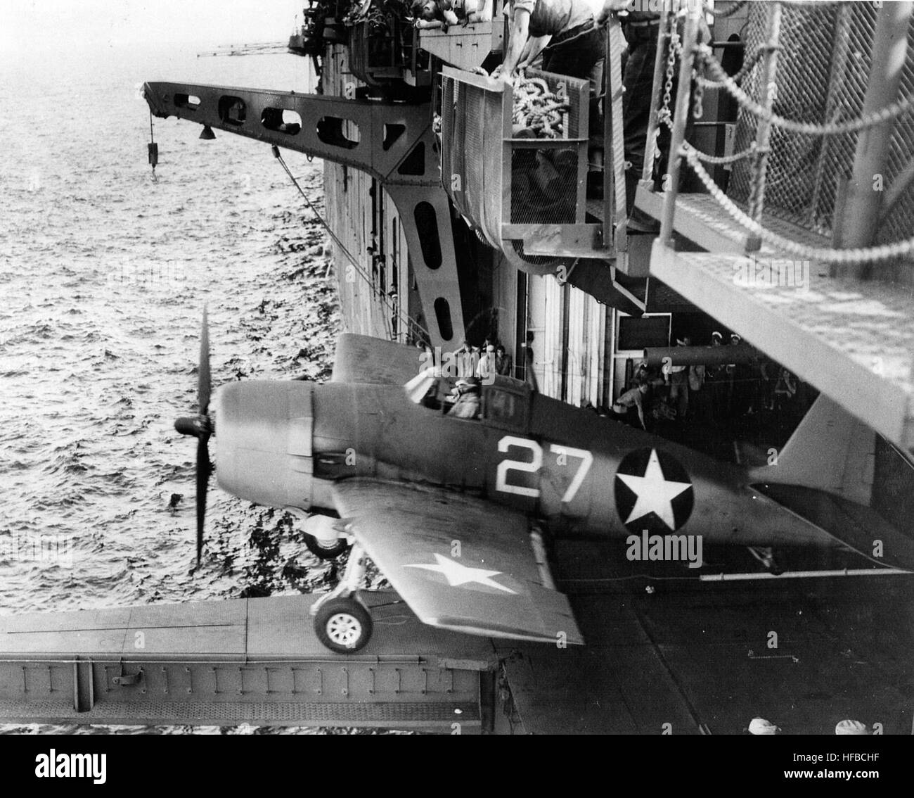 An F6F Hellcat fighter aircraft is positioned on the hangar catapult ...