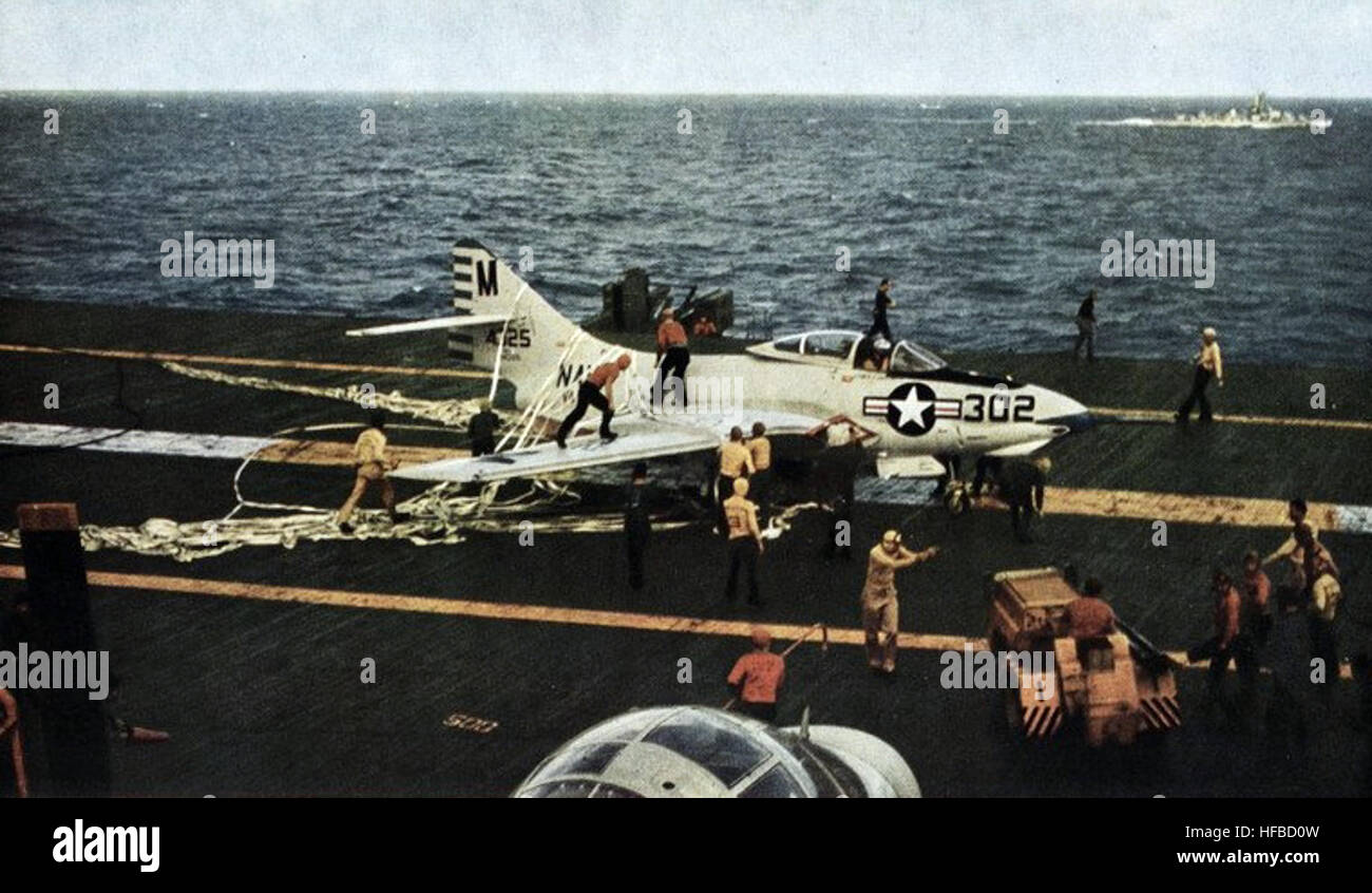 An F9F-8 Panther of VA-63 squadron completes a barrier arrest landing ...