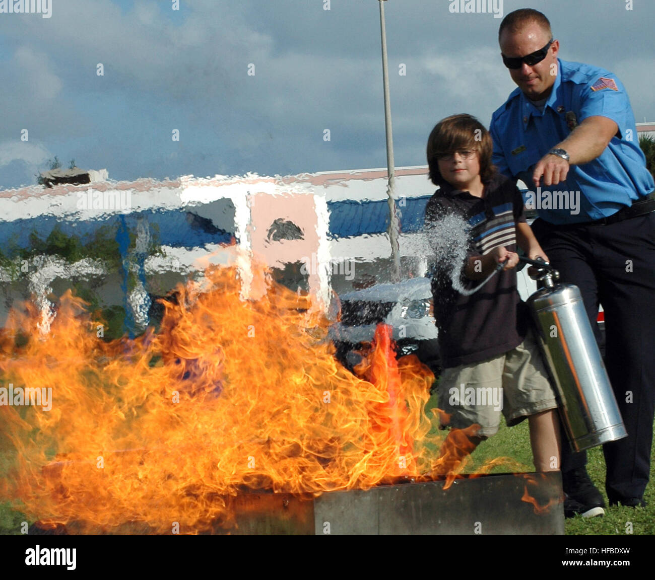 A Naval Air Station Key West firefighter instructs a child on proper ...