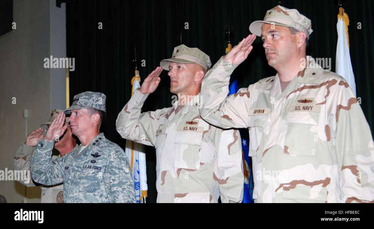 A group of military flag officers renders a salute during a ceremonial ...