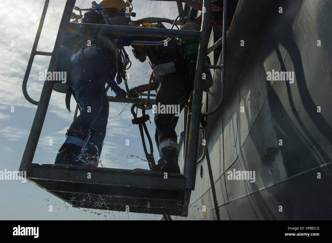 Navy Divers from Mobile Diving and Salvage Unit Two are lifted aboard ...