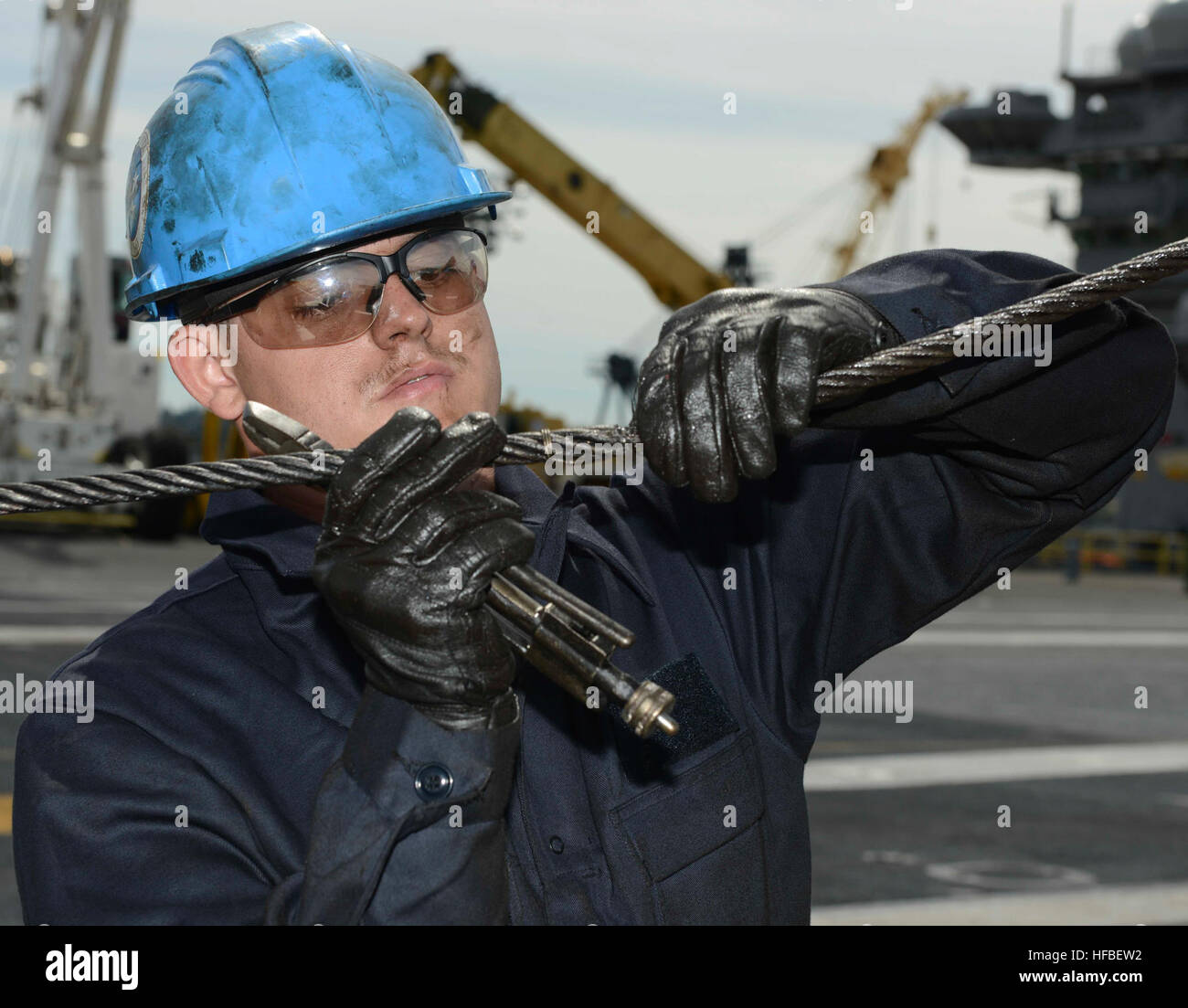 Cables on the USS Nimitz aircraft carrier are spliced during extended ...