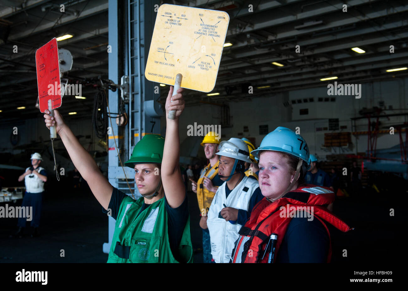 ARABIAN SEA (Nov. 8, 2012) Seaman Amanda Brown signals to the Military ...