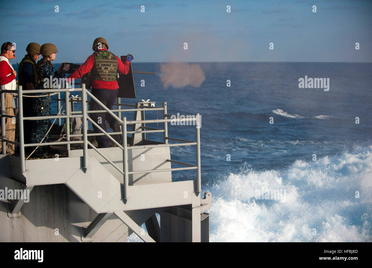 Sailors fire a .50-caliber machine gun during a familiarization ...