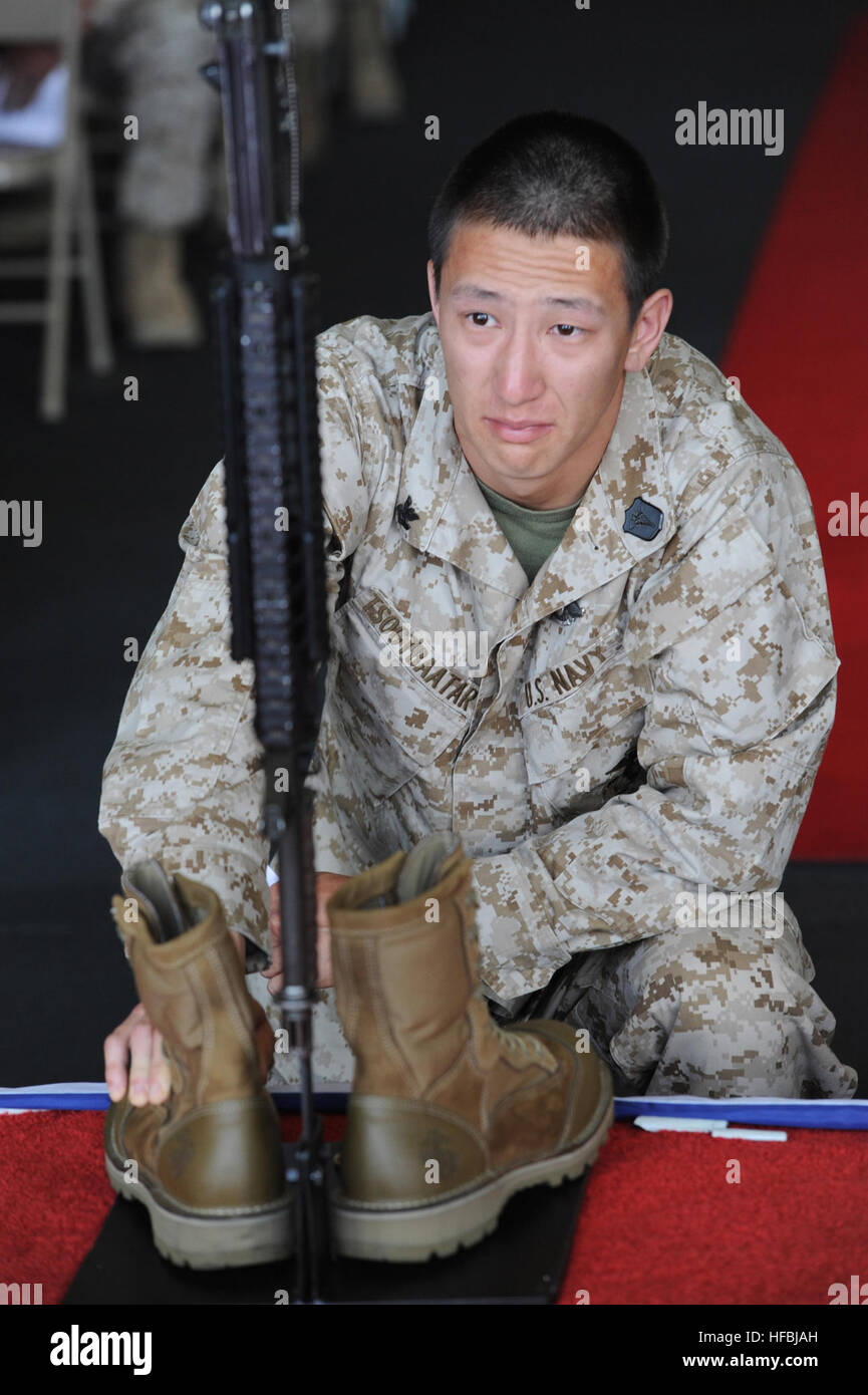 Hospital Corpsman pays respects during a memorial service aboard ...