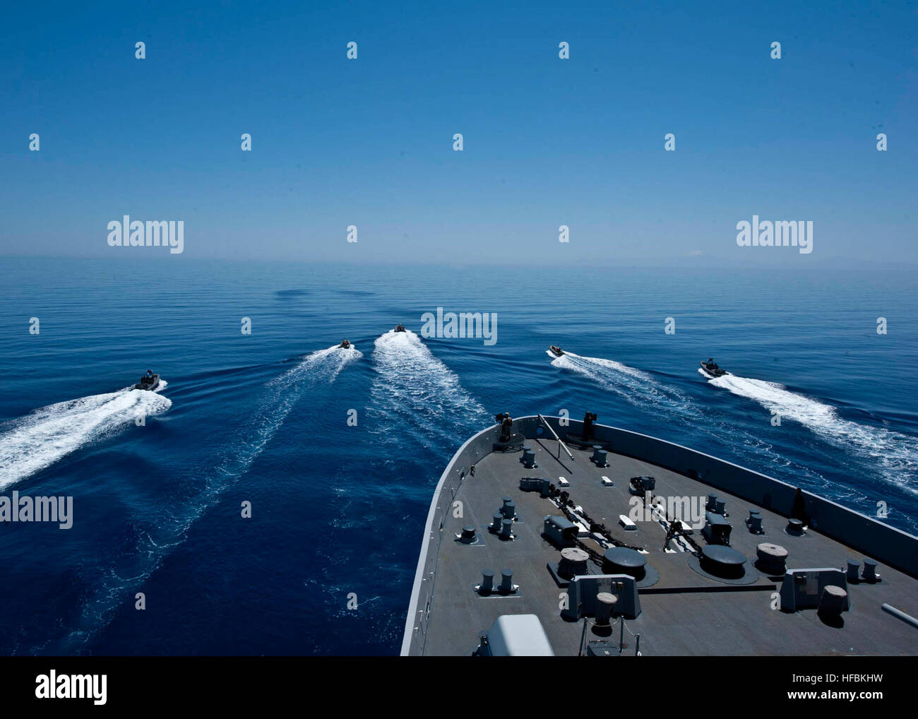 Rigid hull inflatable boats maneuvered in formation ahead of USS New ...