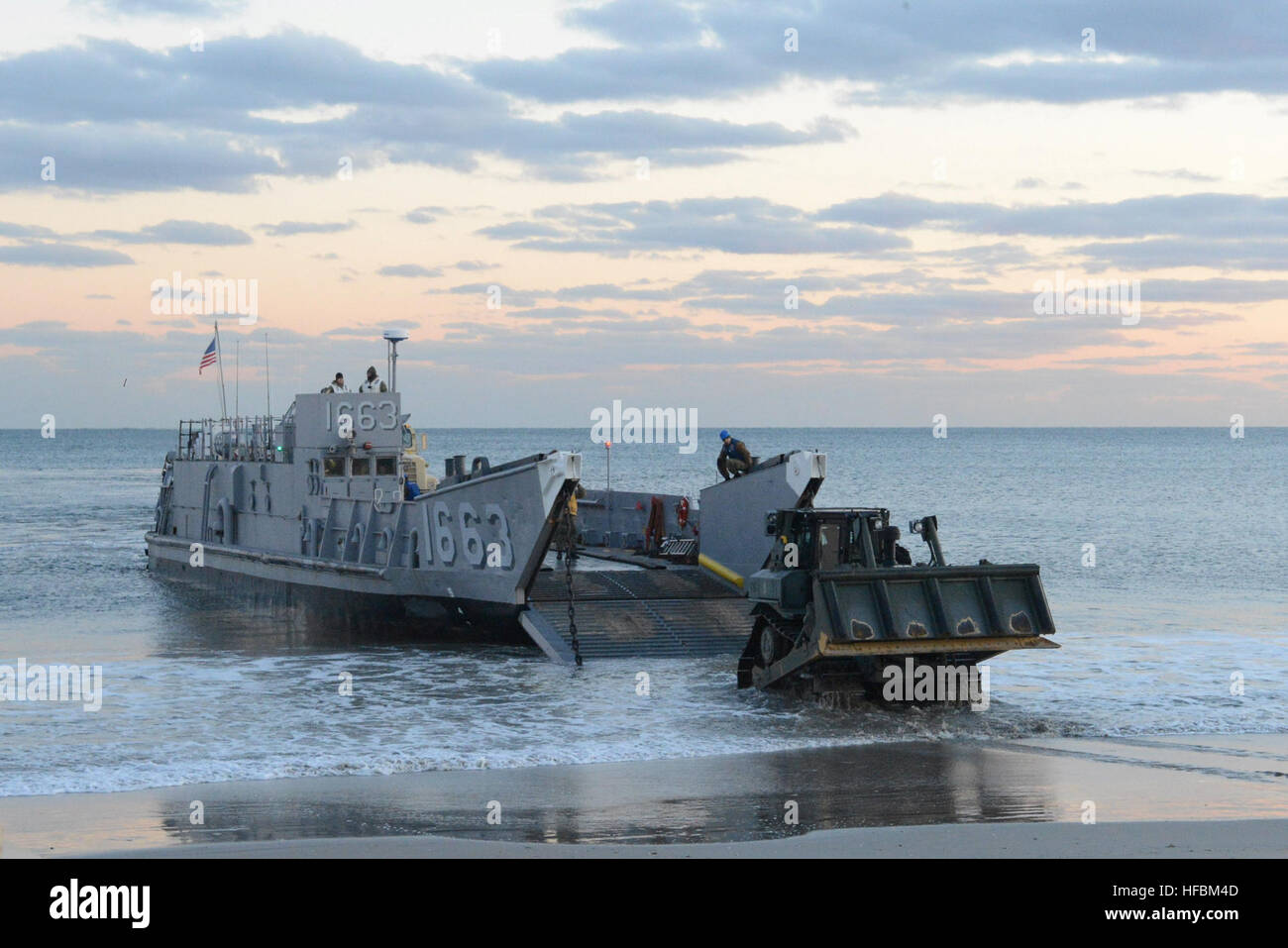 NEW YORK (Nov. 5, 2012) Sailors load a bulldozer onto an amphibious ...