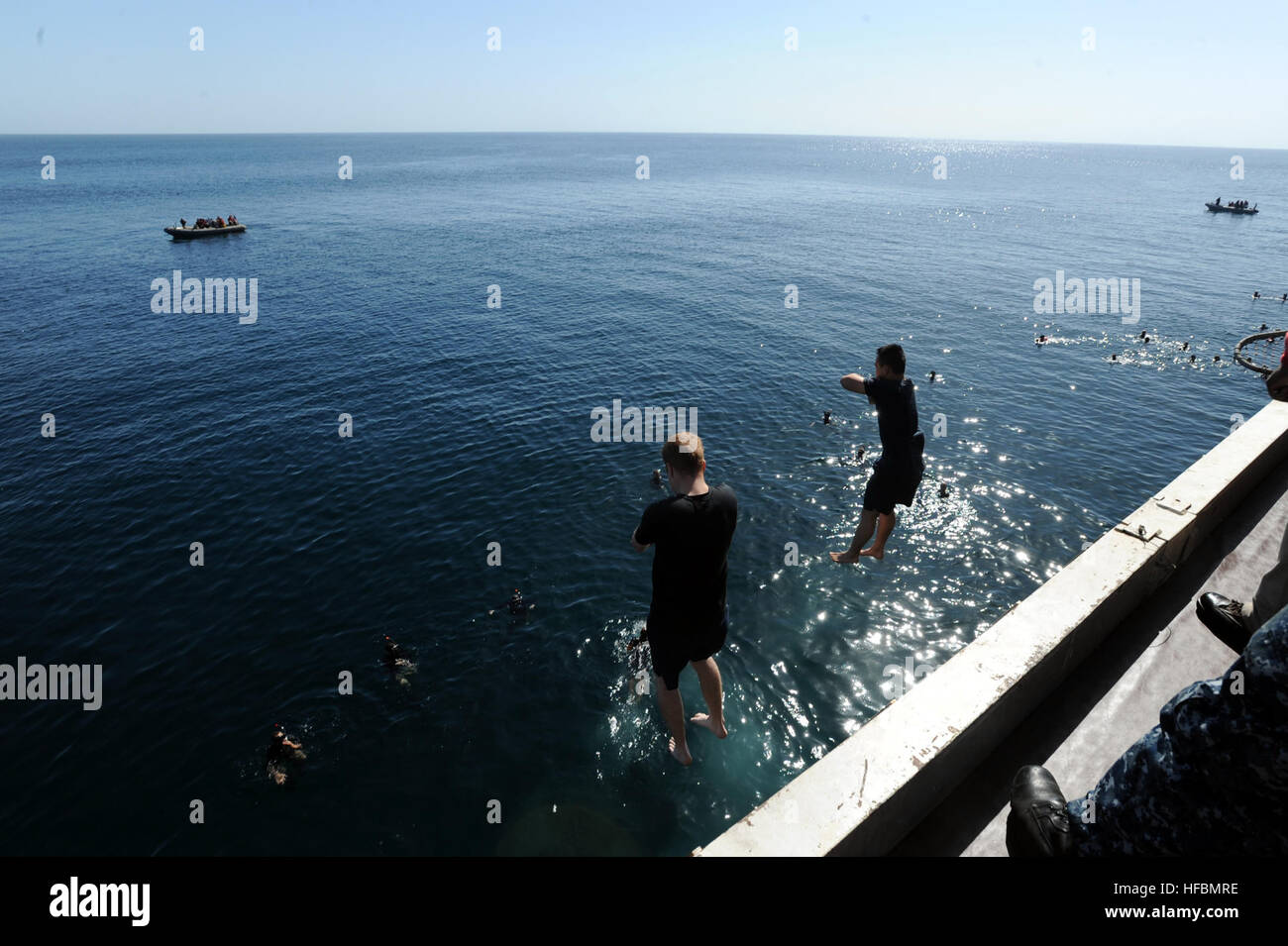 Sailors participate in a swim call from an aircraft elevator aboard the ...