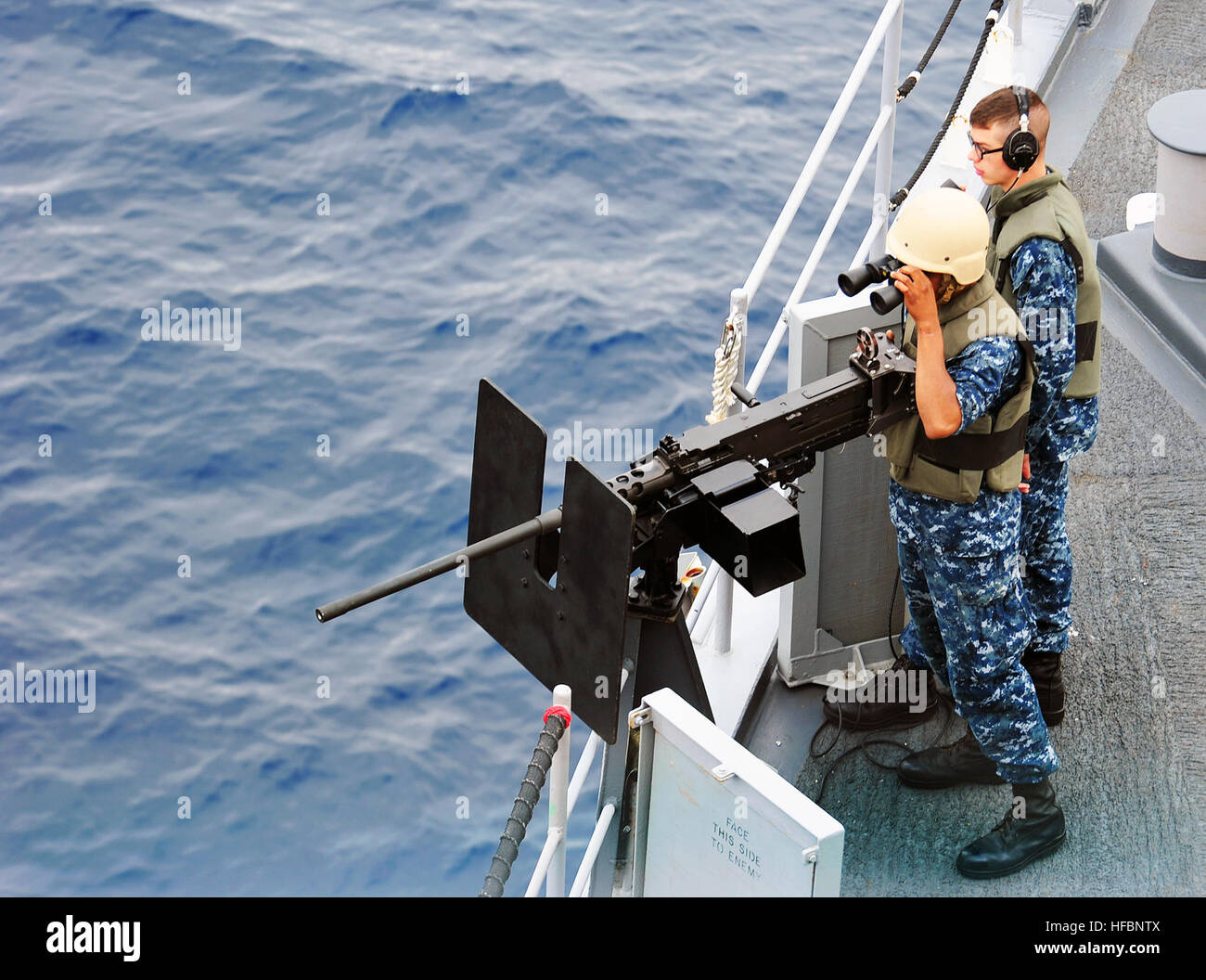 Sailors aboard USS Rushmore (LSD 47) stand lookout watch as part of the ...