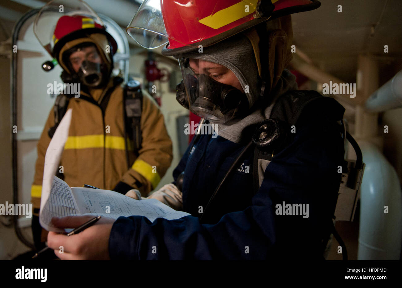 Sailors aboard USS Carl Vinson respond to a simulated class alpha fire ...