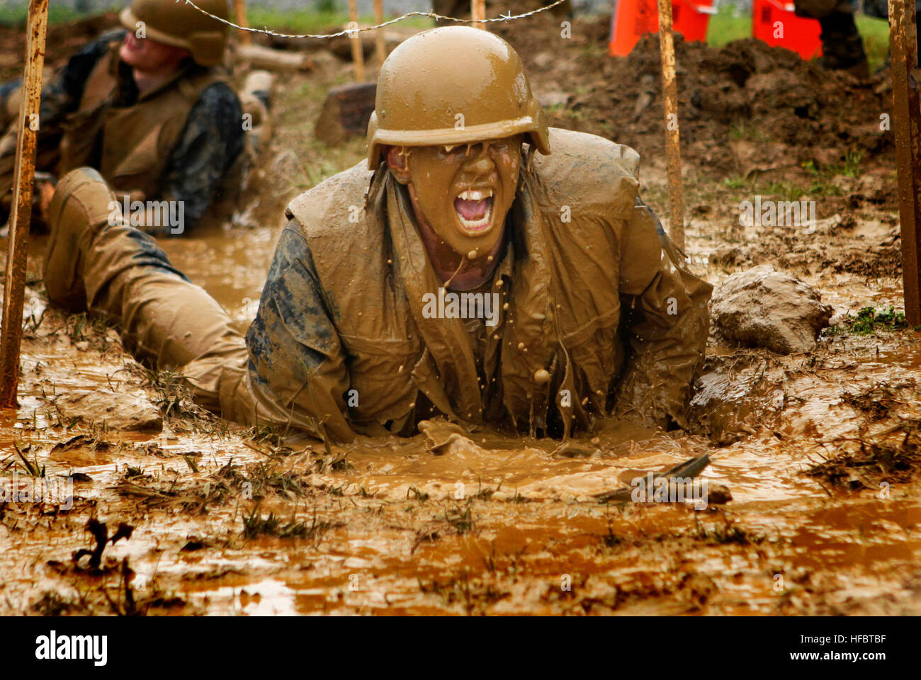U.S. Naval Academy plebes navigate a low crawl obstacle during Sea ...