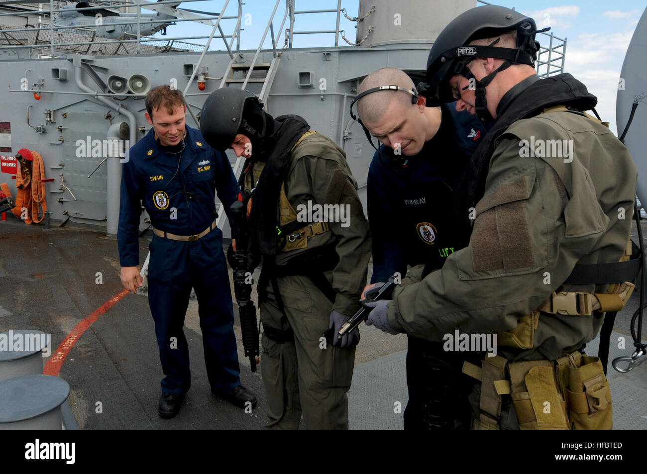Sailors aboard the guided-missile cruiser USS Normandy (CG 60) conduct ...