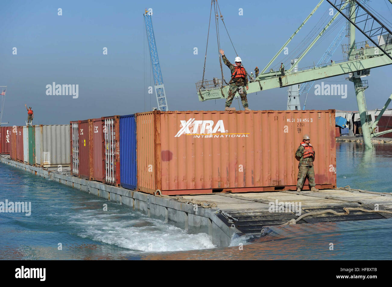 A floating causeway delivers relief aid from Military Sealift Command ...