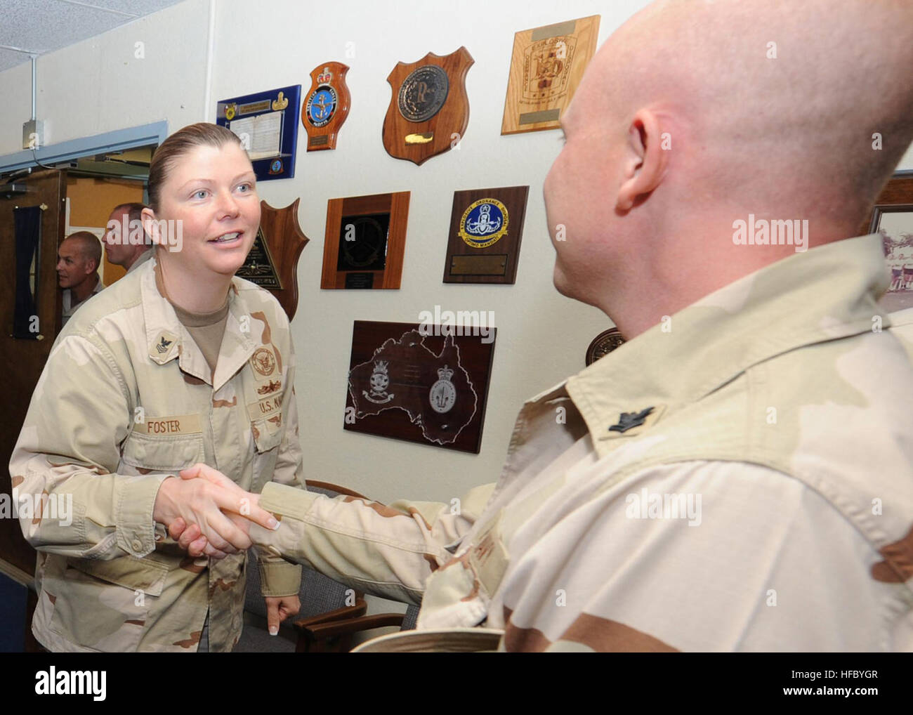 Petty Officer 1st Class Susan Foster, left, congratulates Petty Officer ...