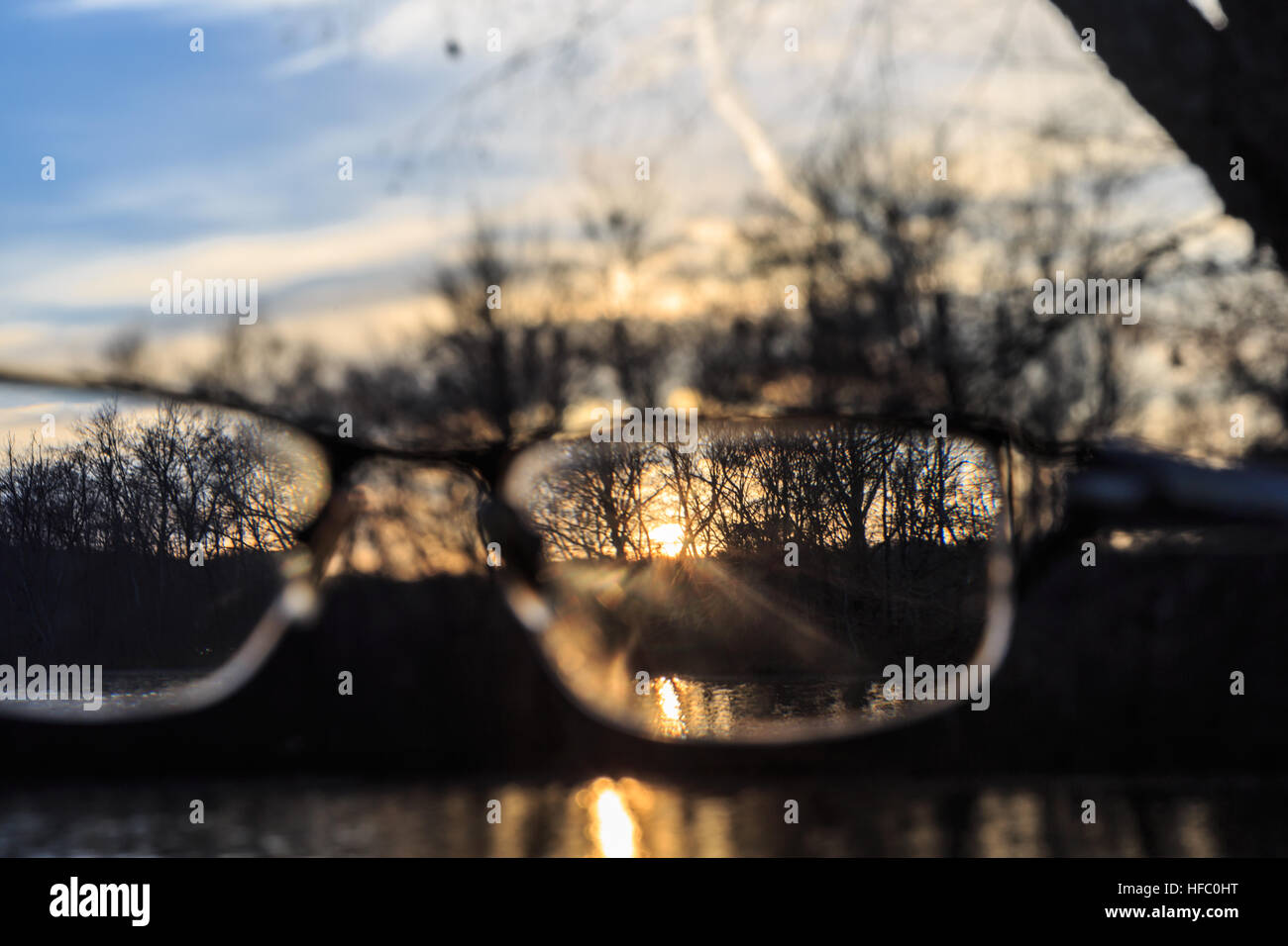 Seeing sun between trees sharp with eyeglasses Stock Photo - Alamy