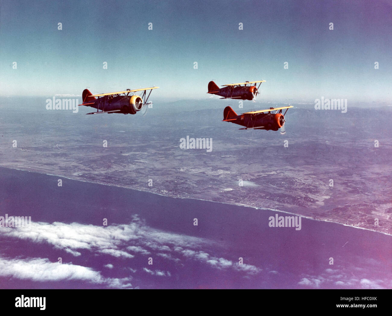 A Grumman F3F-3 biplane fighter aircraft is photographed in flight over ...