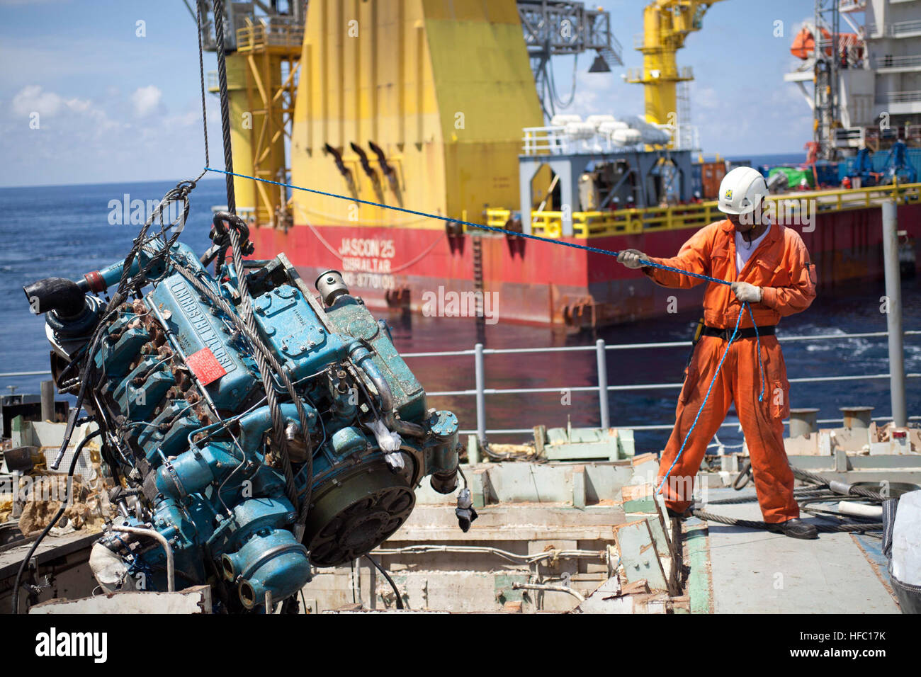 The M/V Jascon 25 and U.S. Navy salvage teams guide the removal of ...