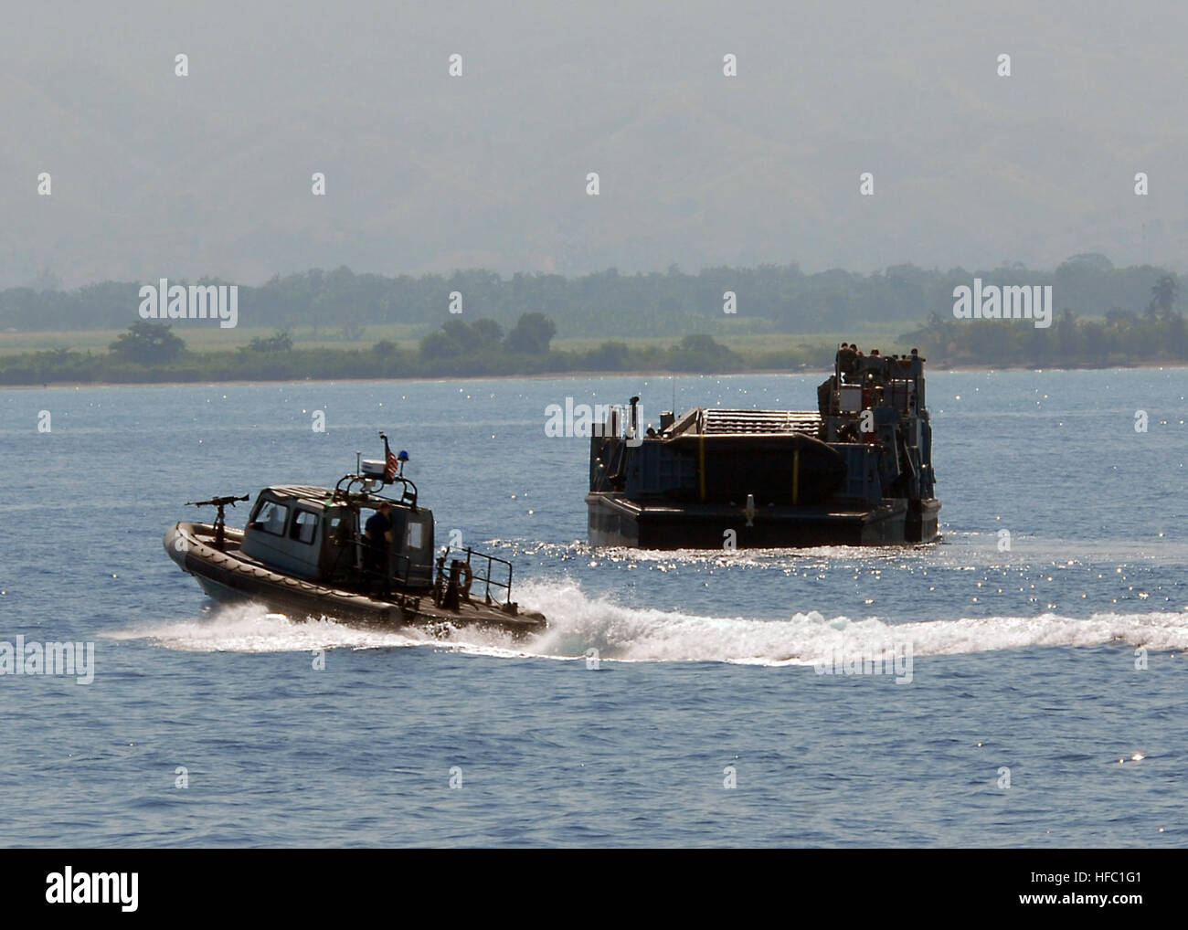 A security boat from Maritime Expeditionary Security Squadron 6 patrols ...