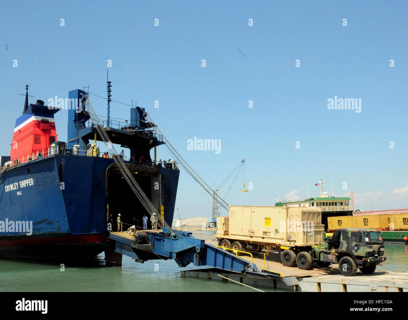 U.S. and international military personnel conduct joint logistics over ...